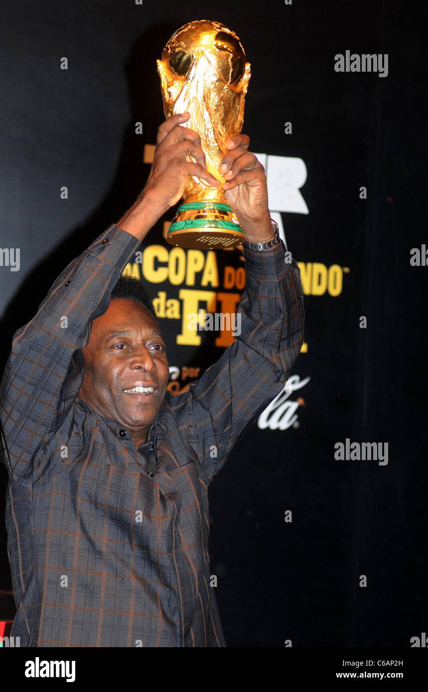 Former football star Pele holds up the FIFA World Cup trophy. The ...