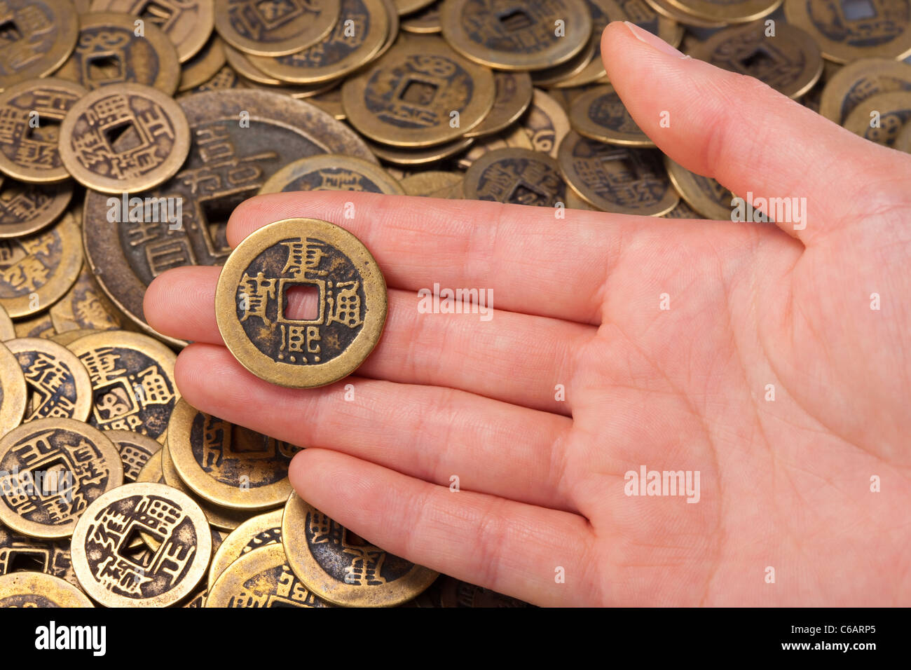 Hand holding traditional Chinese coin Stock Photo - Alamy