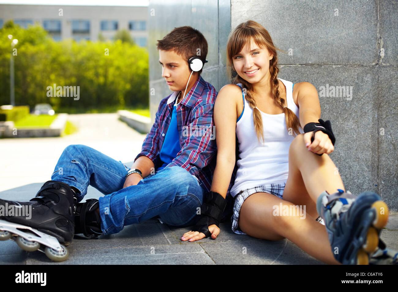 Couple of happy teens spending free time outside Stock Photo - Alamy