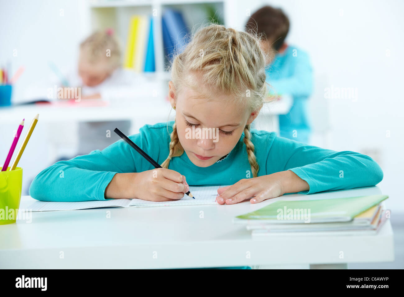 Portrait of lovely girl drawing with classmates on background Stock ...