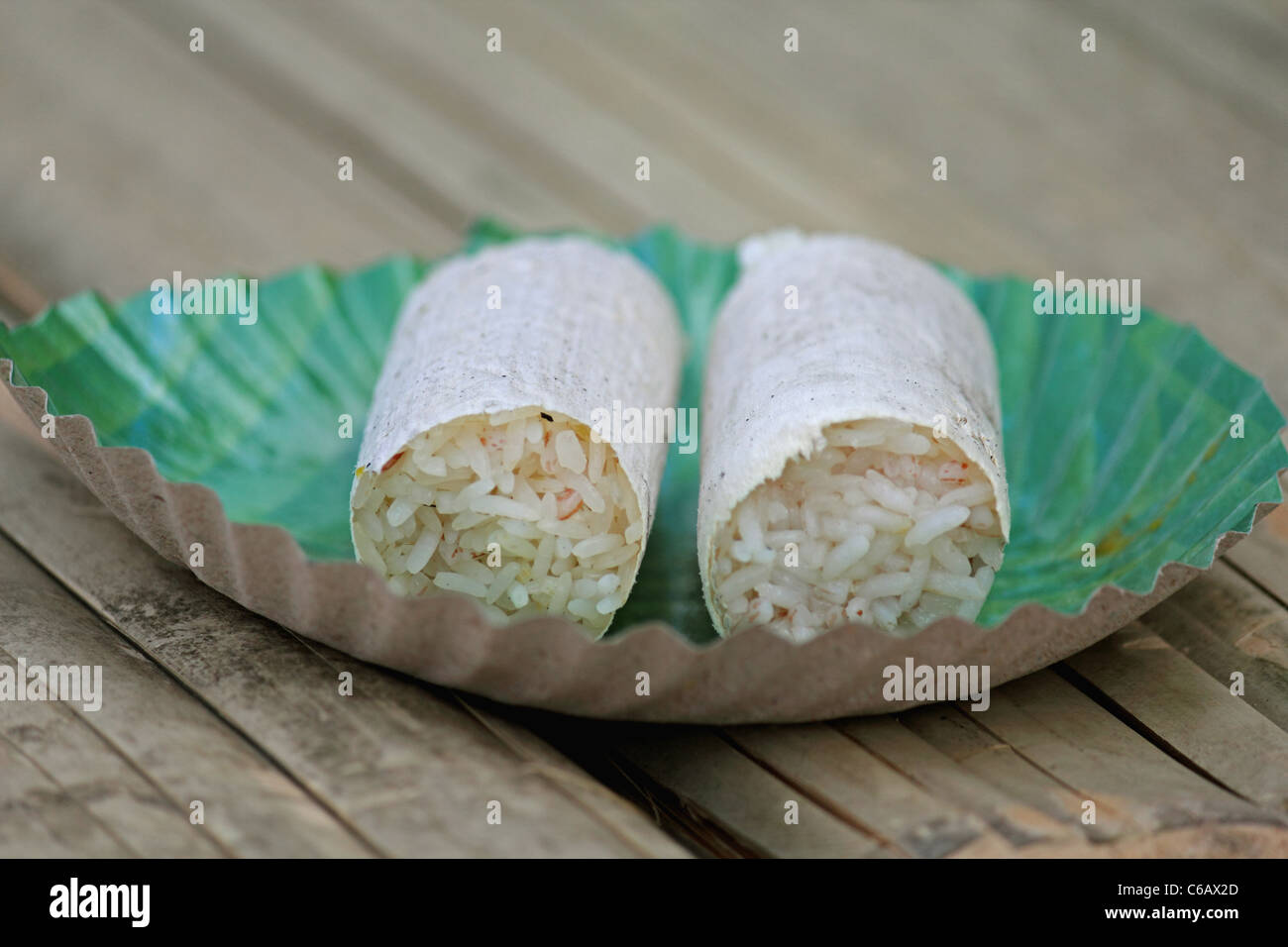 Rice steamed in bamboo tube served in a paper dish, Miao, arunachal ...