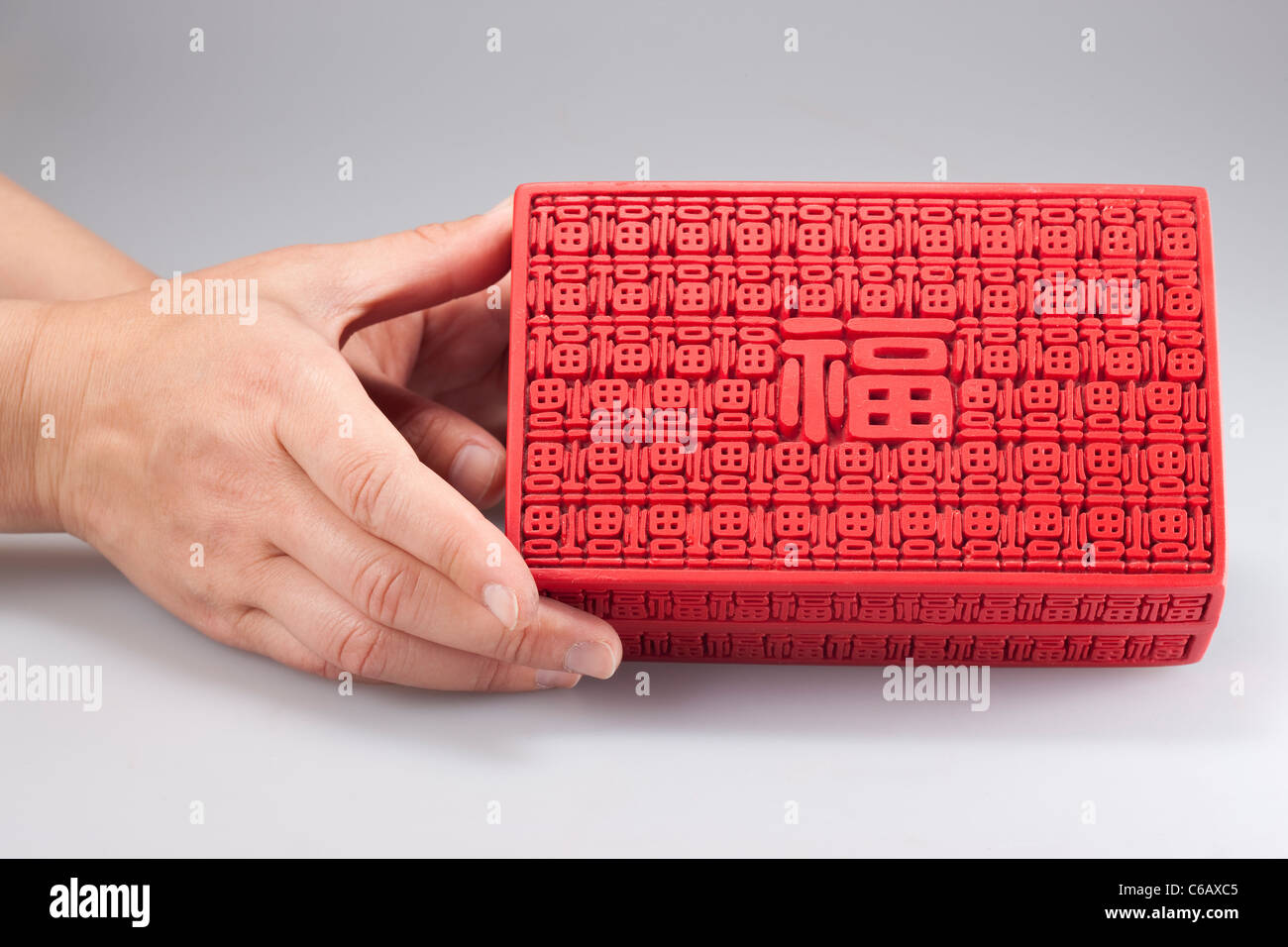Hand holding traditional Chinese box Stock Photo - Alamy