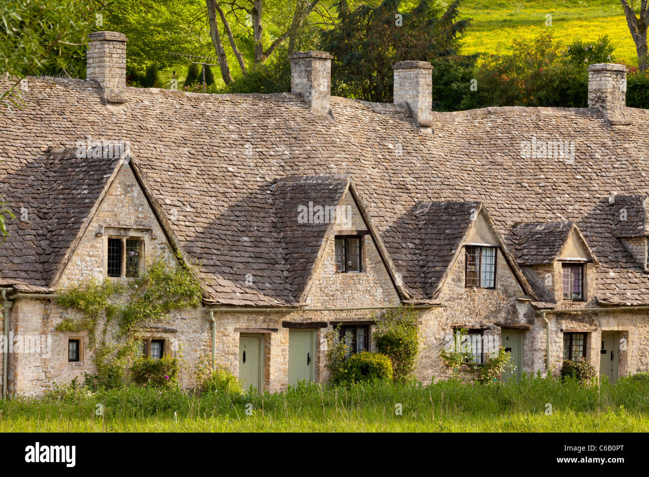 Evening sunlight falling on Arlington Row in the Cotswold village of ...