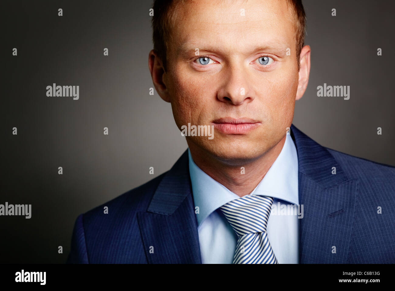 Portrait of young handsome businessman looking at camera Stock Photo ...