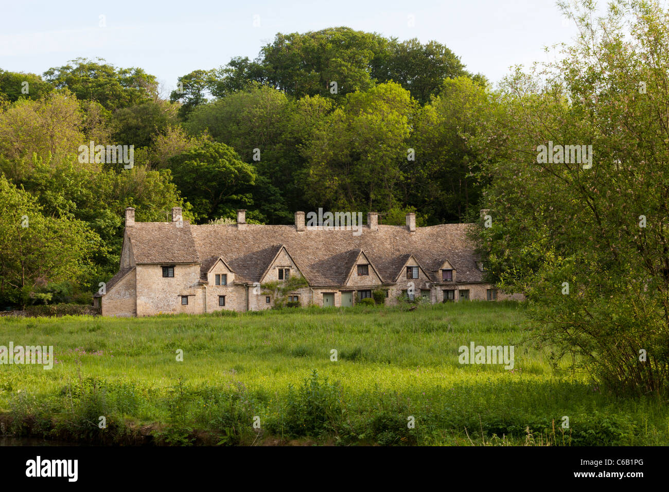 Evening sunlight falling on Arlington Row in the Cotswold village of ...