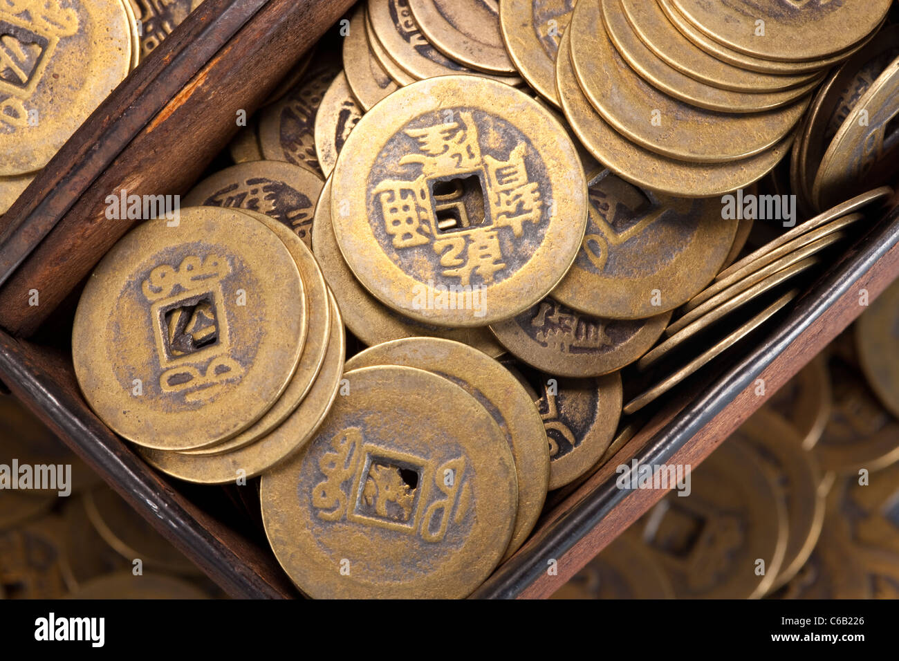 Close-up of a wooden box full of ancient Chinese coins Stock Photo - Alamy