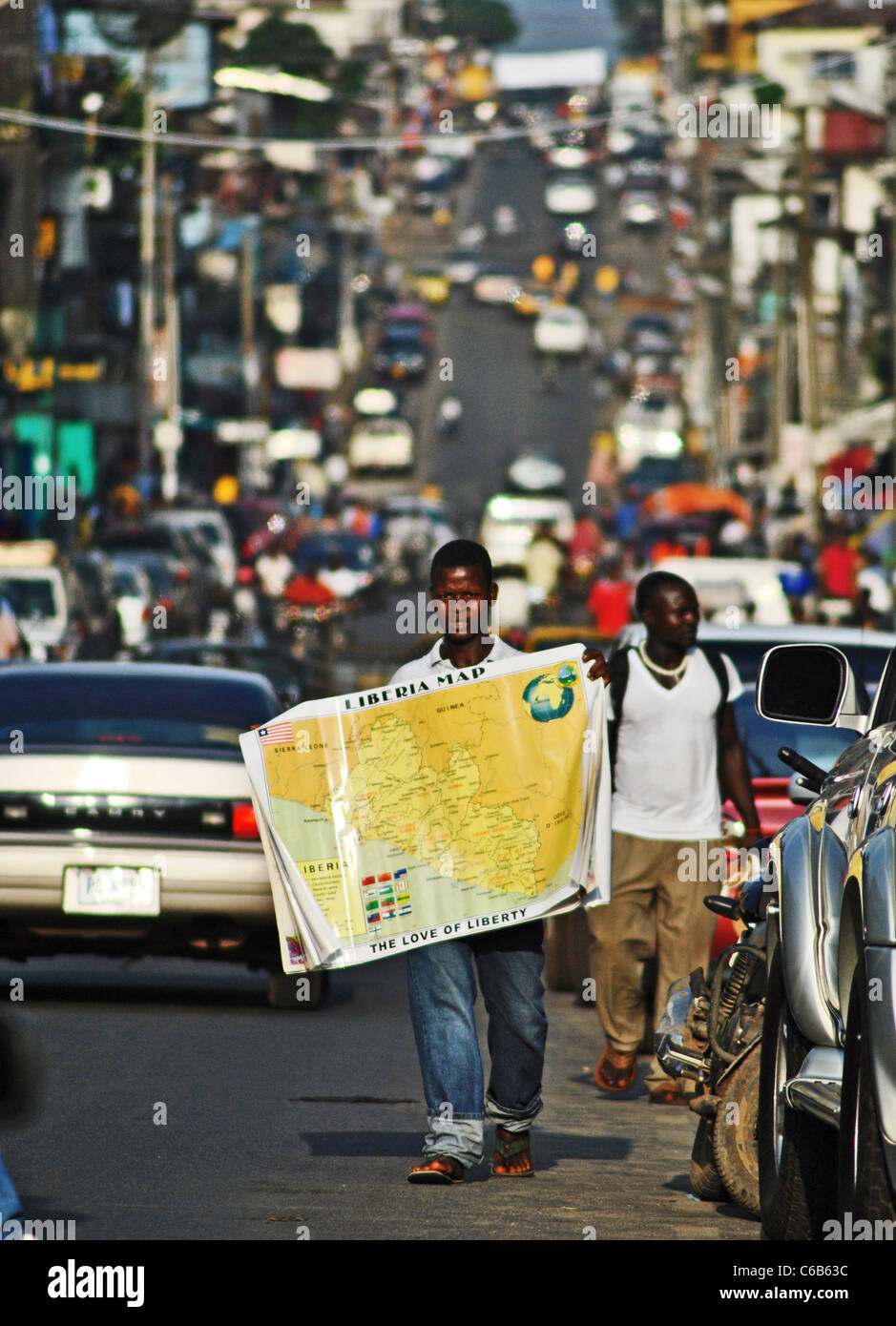 Vendor selling maps of Liberia in central Monrovia Stock Photo - Alamy