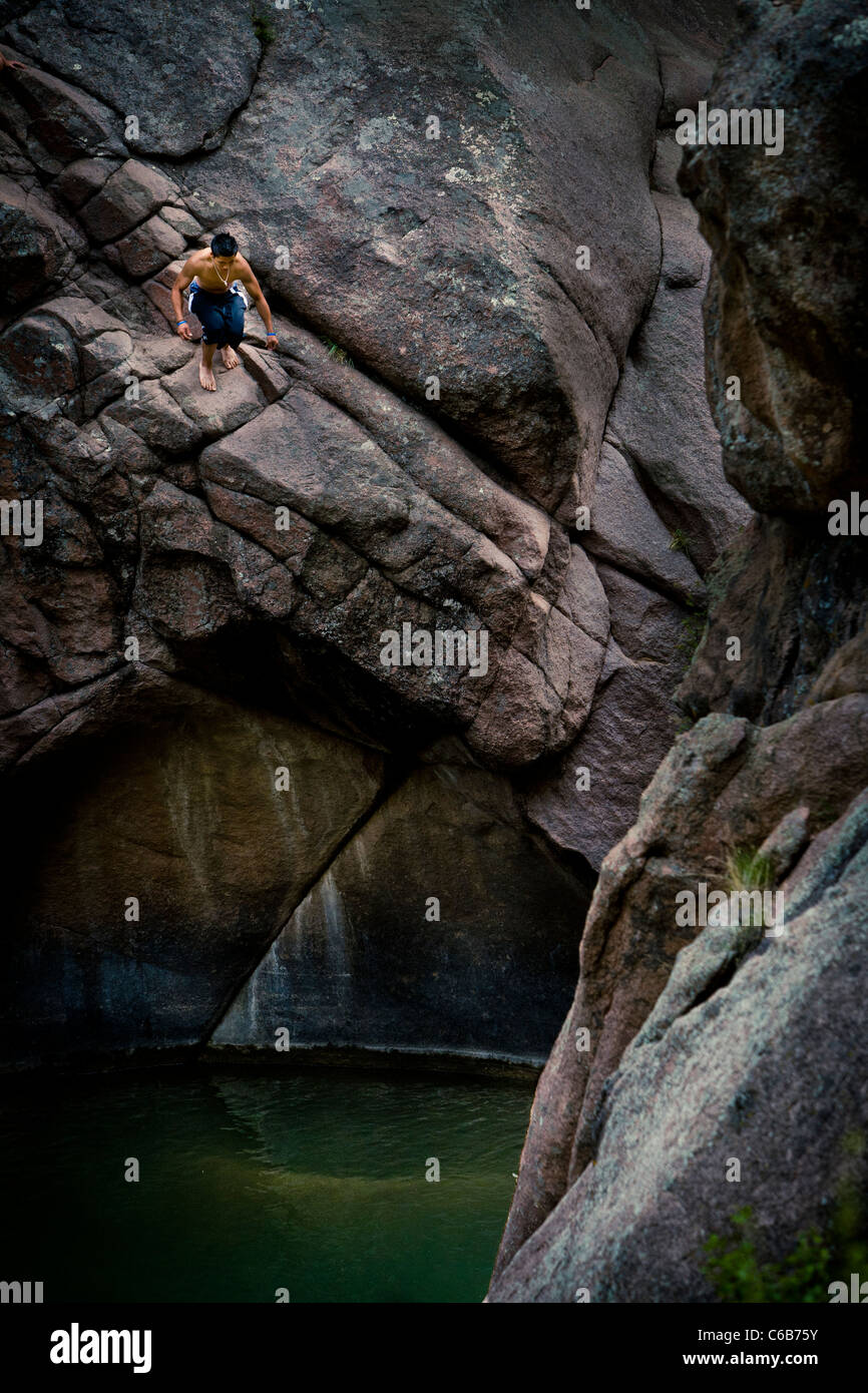 A boy diving off a cliff rock Stock Photo - Alamy