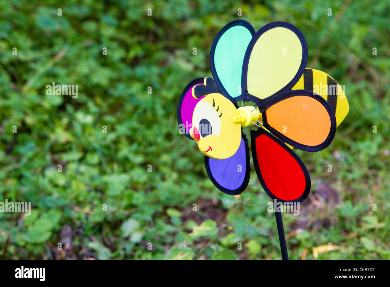 Colourful toy windmill in the shape of a bee Stock Photo - Alamy