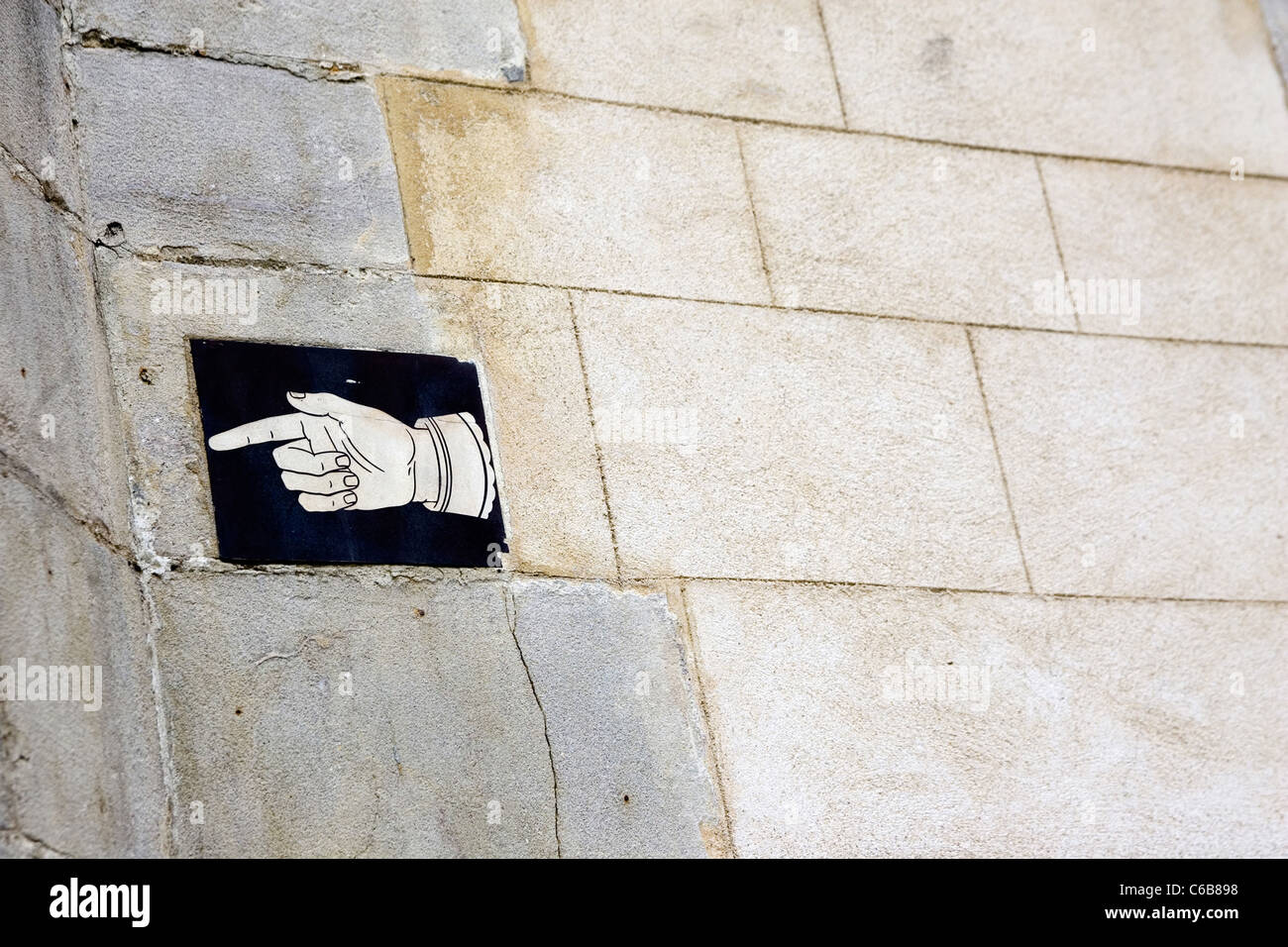 A directional hand points the direction on a wall. Temple Court, London ...
