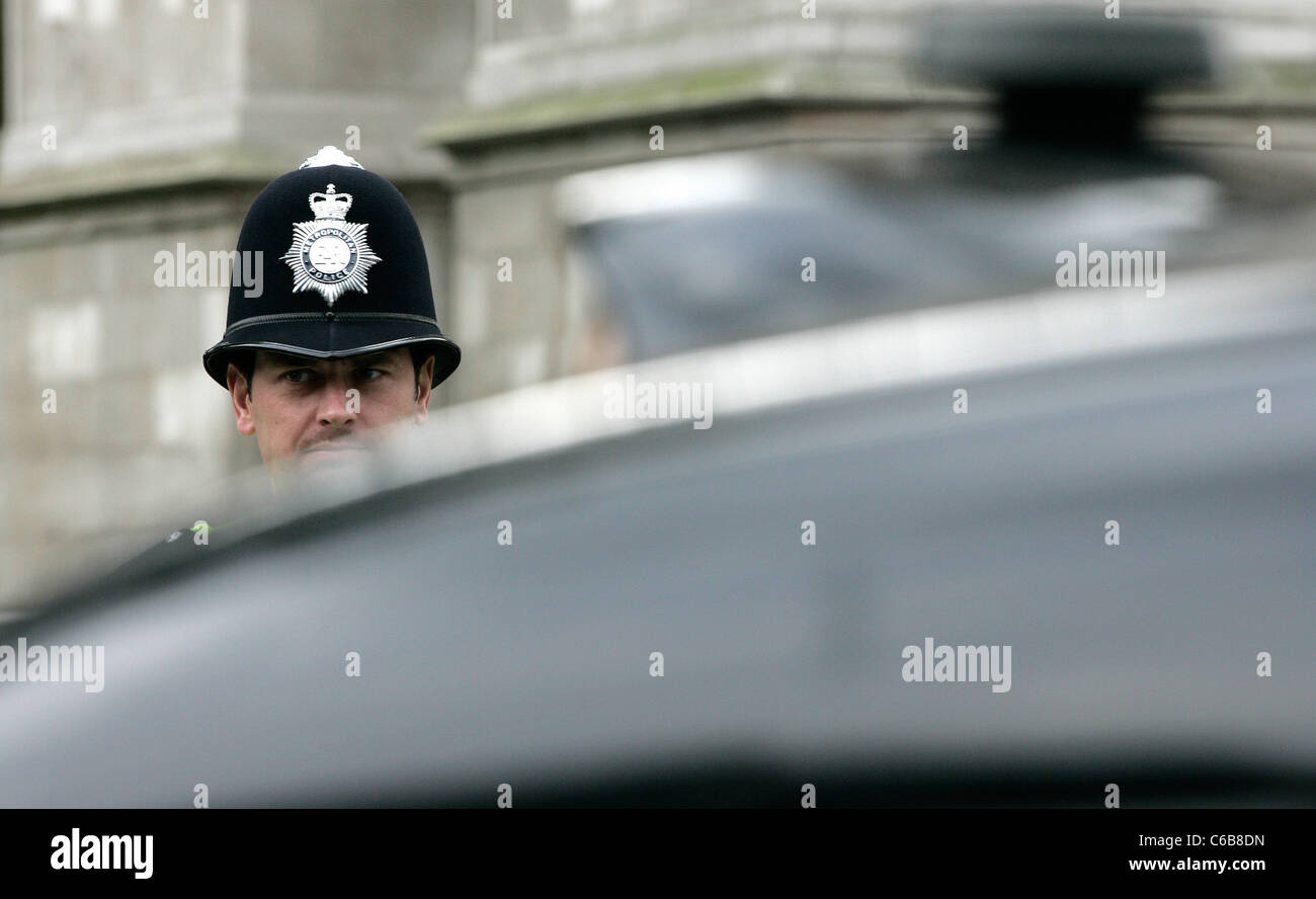 A Metropolitan police officer on watch wearing the traditional bobby ...