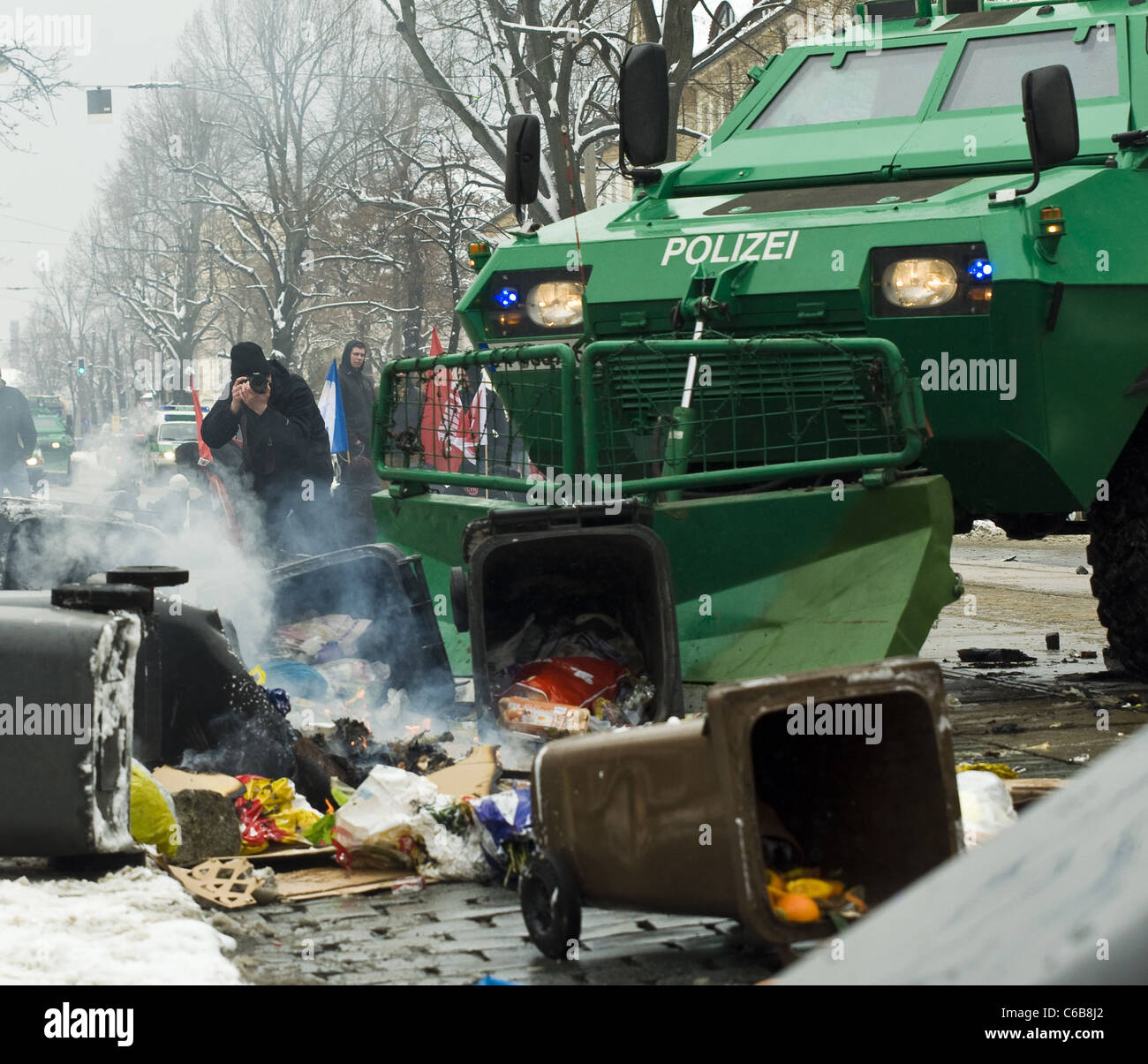Police clear a barricade of burning wheelie bins in Neustadt during ...
