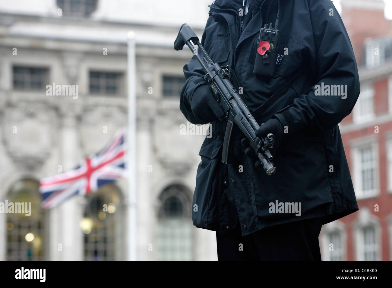 Armed Metropolitan police officer with the British Union Jack flag at ...