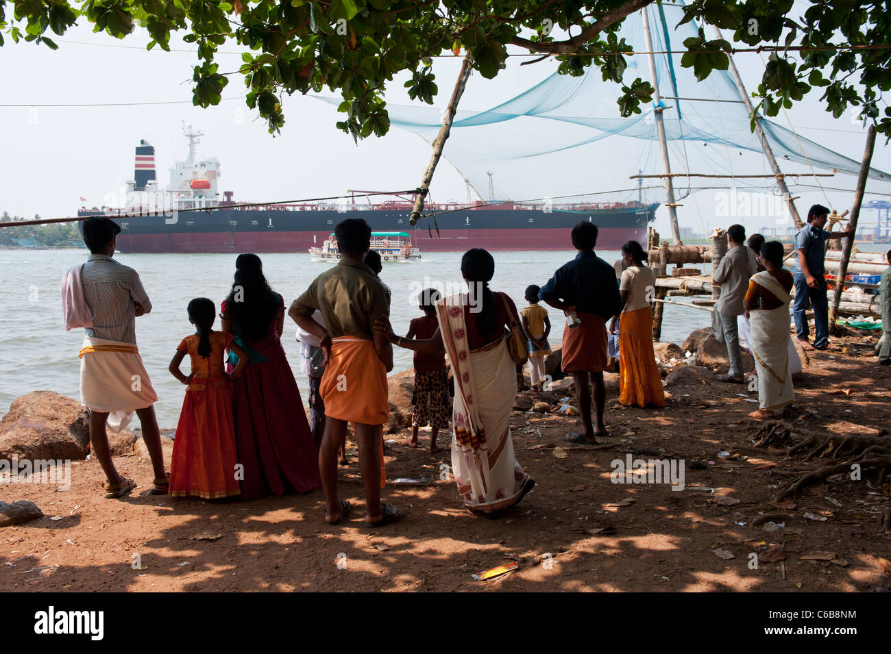 Locals watch as a Large Container Ship Sails into Kochi Harbour from ...
