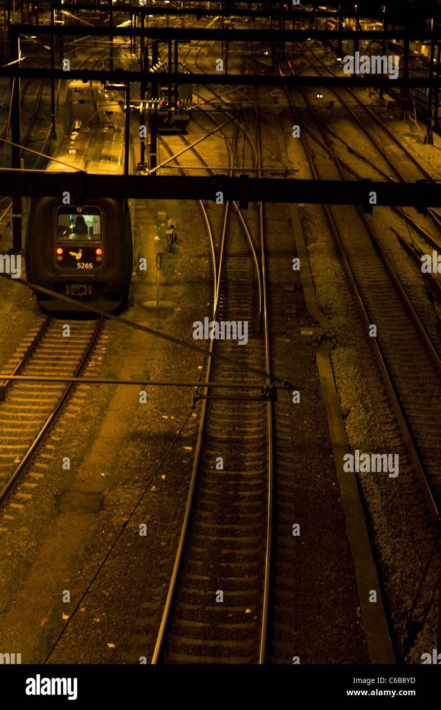 Rail tracks and trains in Copenhagen during night Stock Photo - Alamy