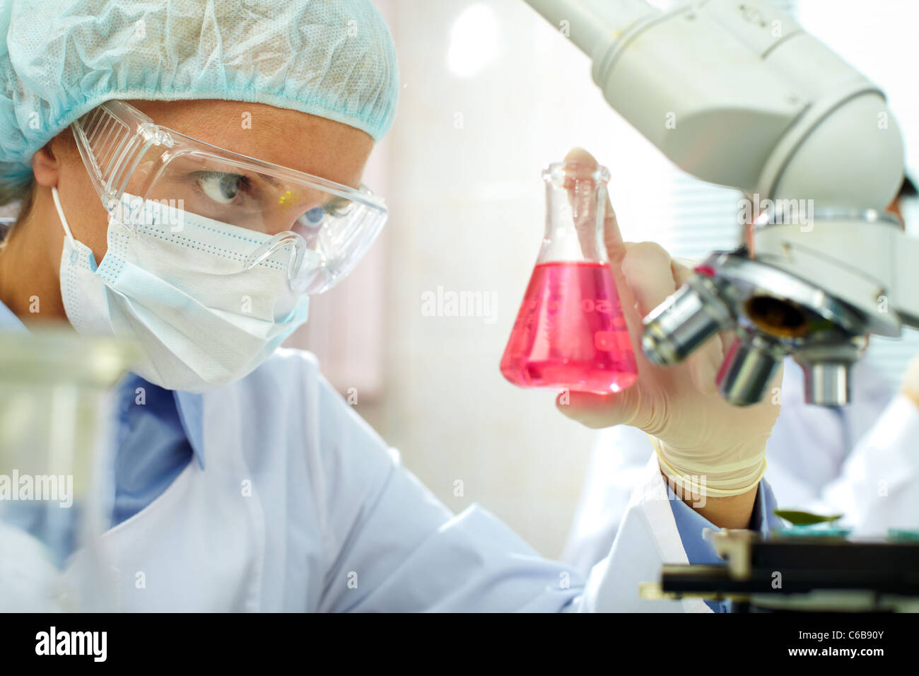 Chemist holding sample of liquid in laboratory Stock Photo - Alamy