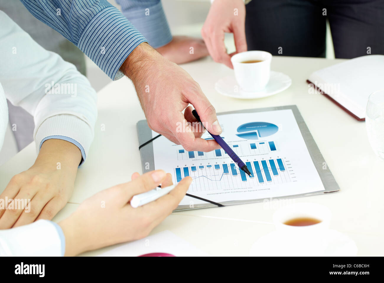 Image of human hand pointing at paper during explanation Stock Photo ...