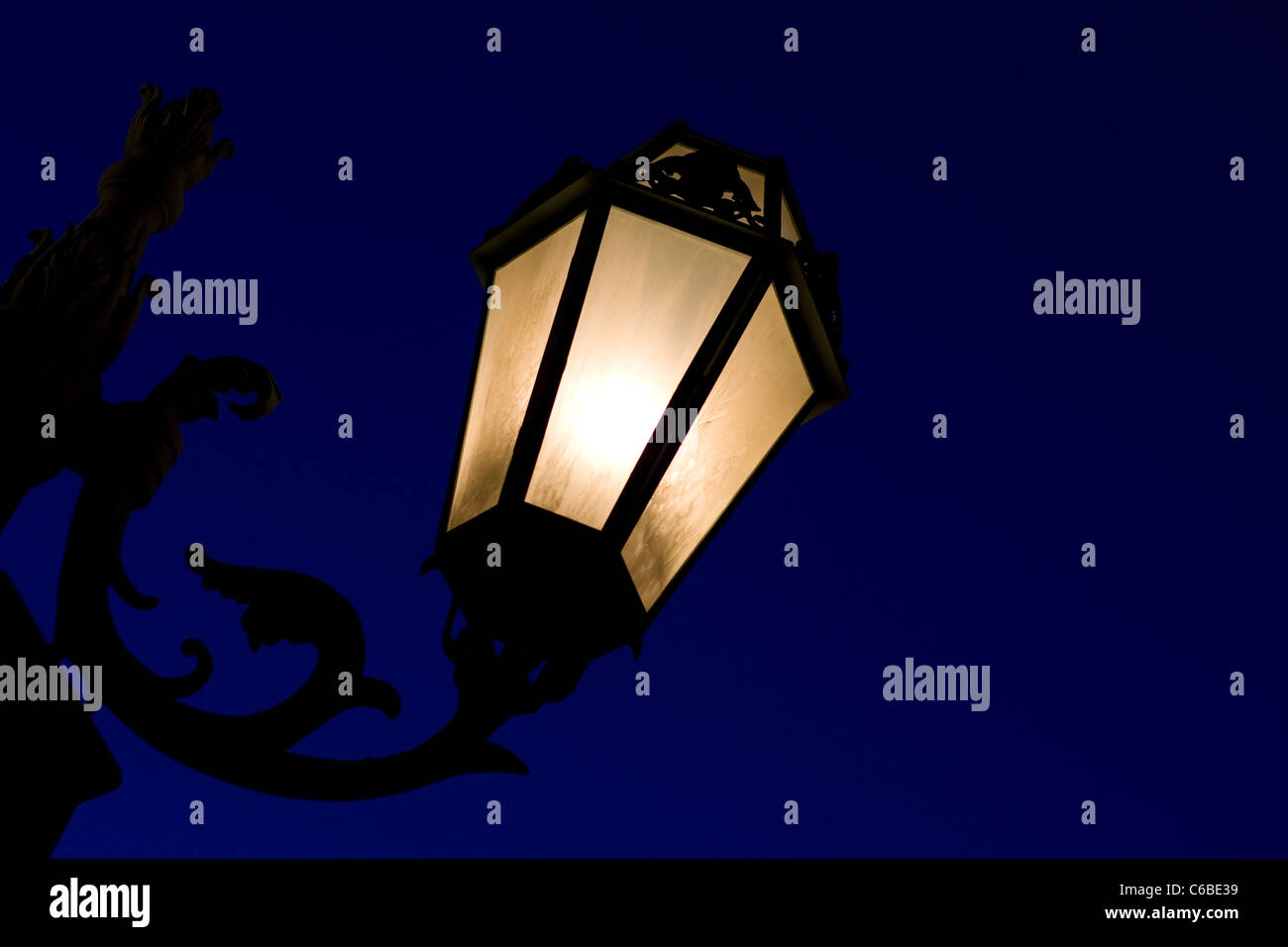 Decorative lamp post photographed in the clear dark blue midnight Stock ...