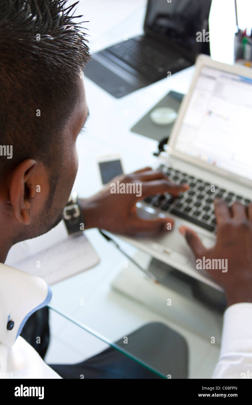 Indian man working on his personal computer Stock Photo - Alamy