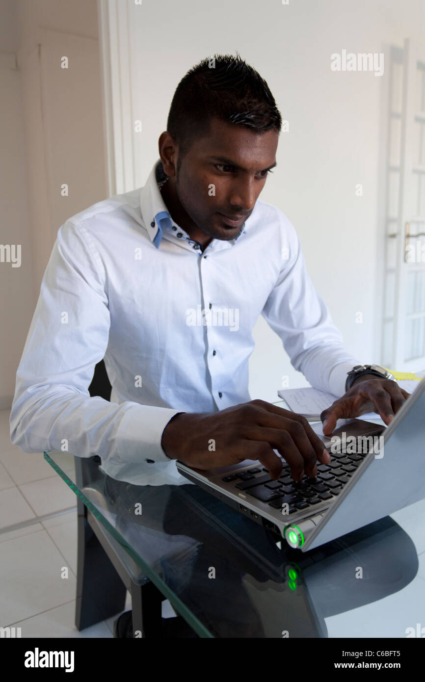 Indian man working on his personal computer Stock Photo - Alamy