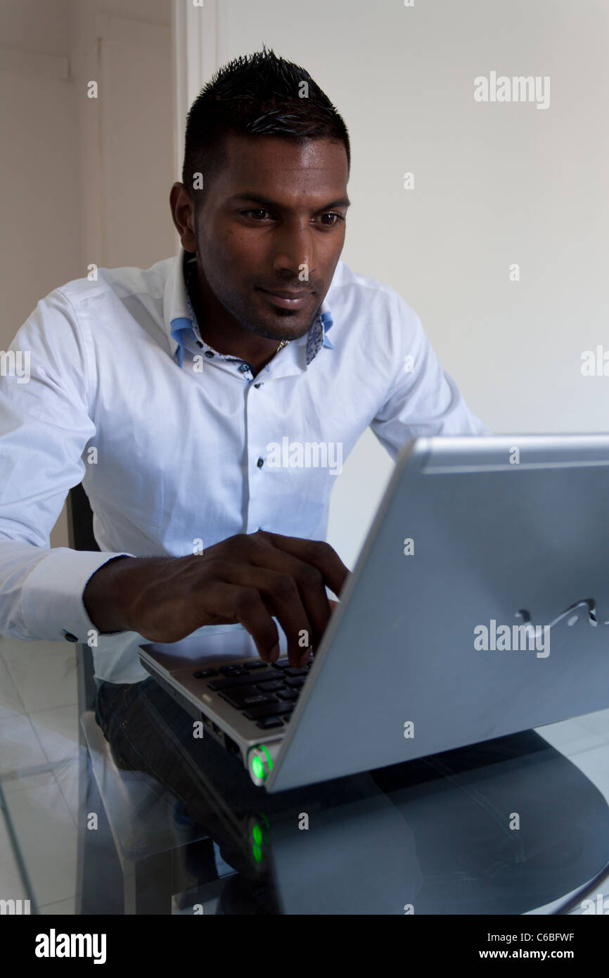 Indian man working on his personal computer Stock Photo - Alamy