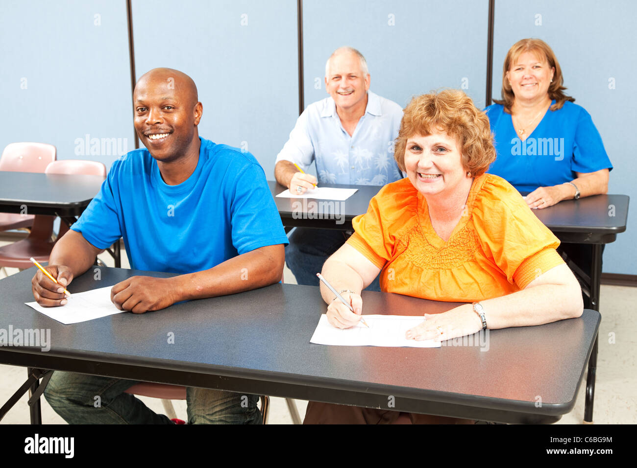 Happy, diverse group of adult education students in class Stock Photo ...