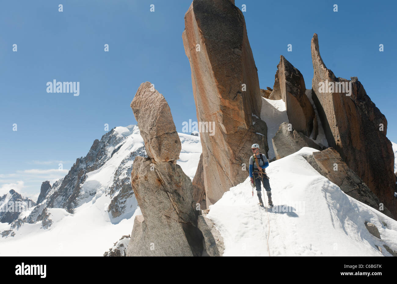 A male mountaineer climbing the Cosmiques ridge in Chamonix, France ...