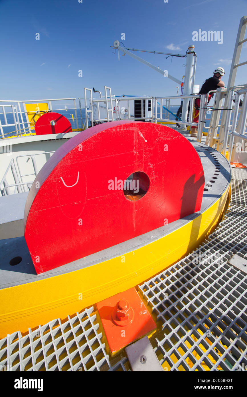 A worker on top of a 320 tonne transition piece on the deck of the jack ...