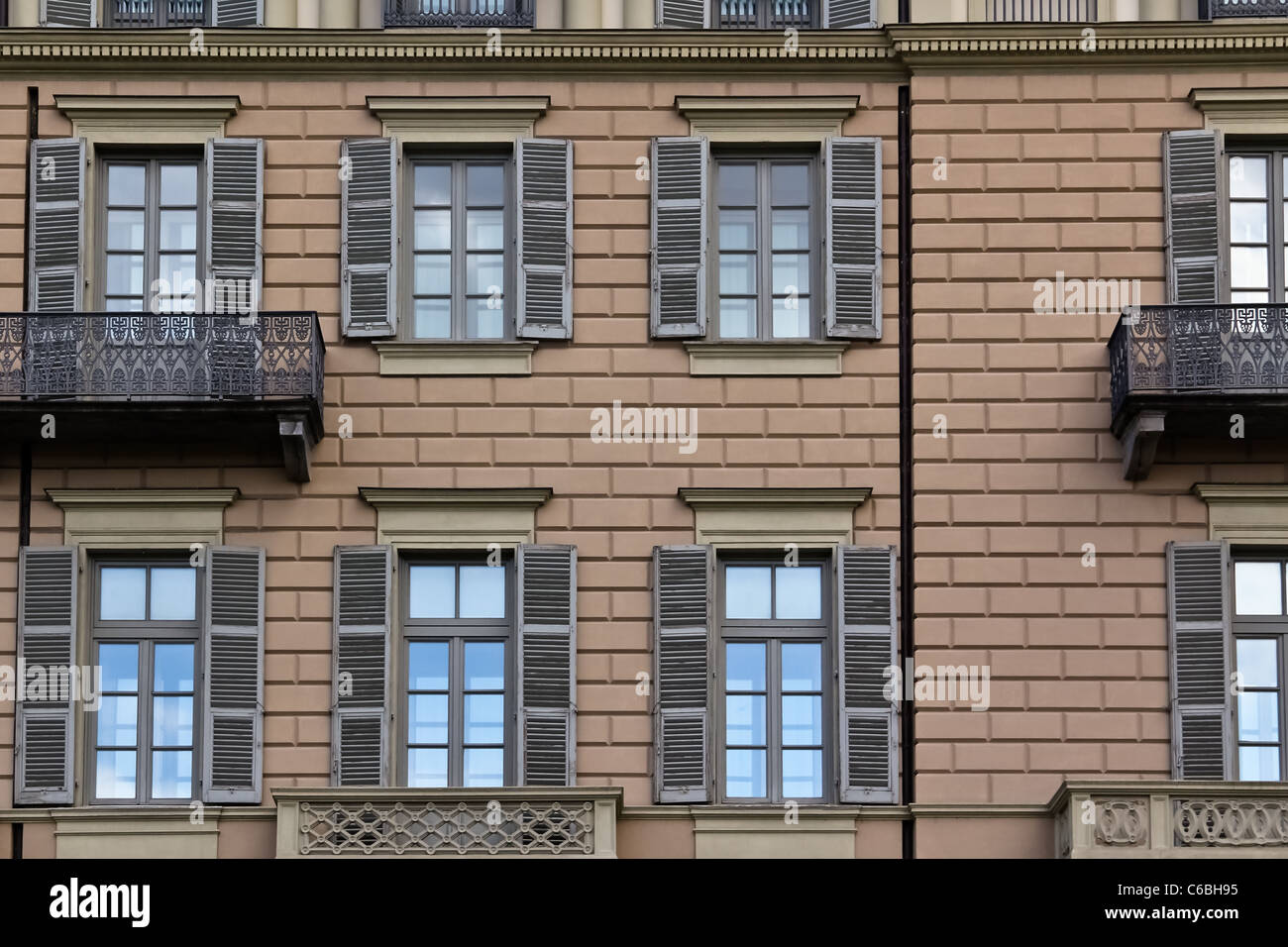 A typical italian house facade with open windows and balconies in ...