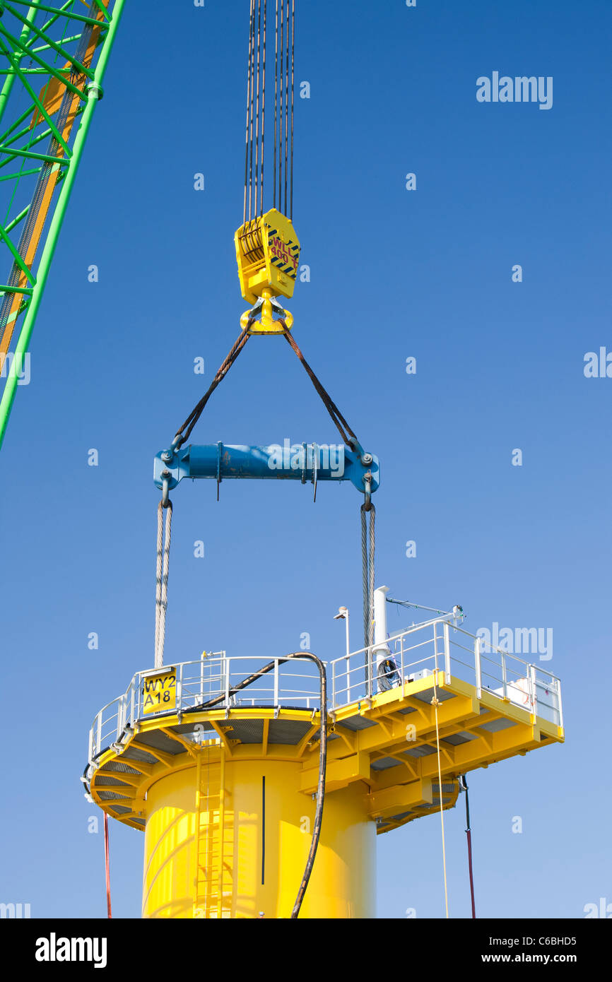 A crane lifts a transition piece into place on the Walney offshore wind ...