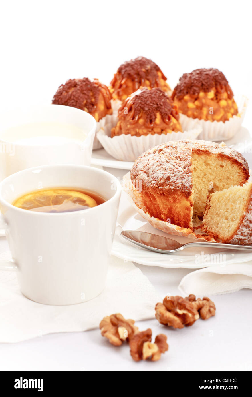tea with lemon and fancy cakes, still life Stock Photo - Alamy