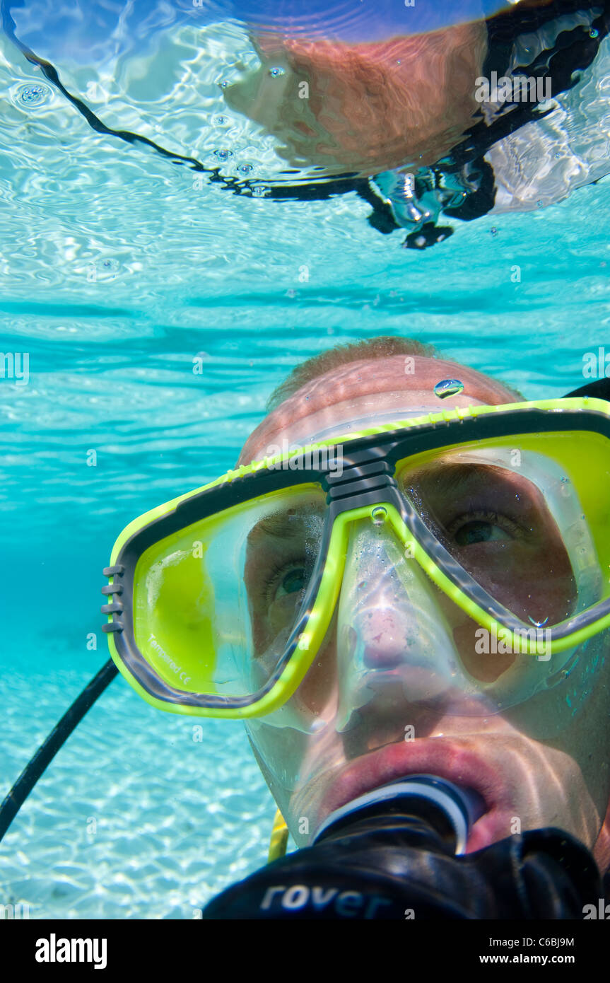 Scuba diver in clear waters, portrait, North Huvadhoo Atoll, The ...