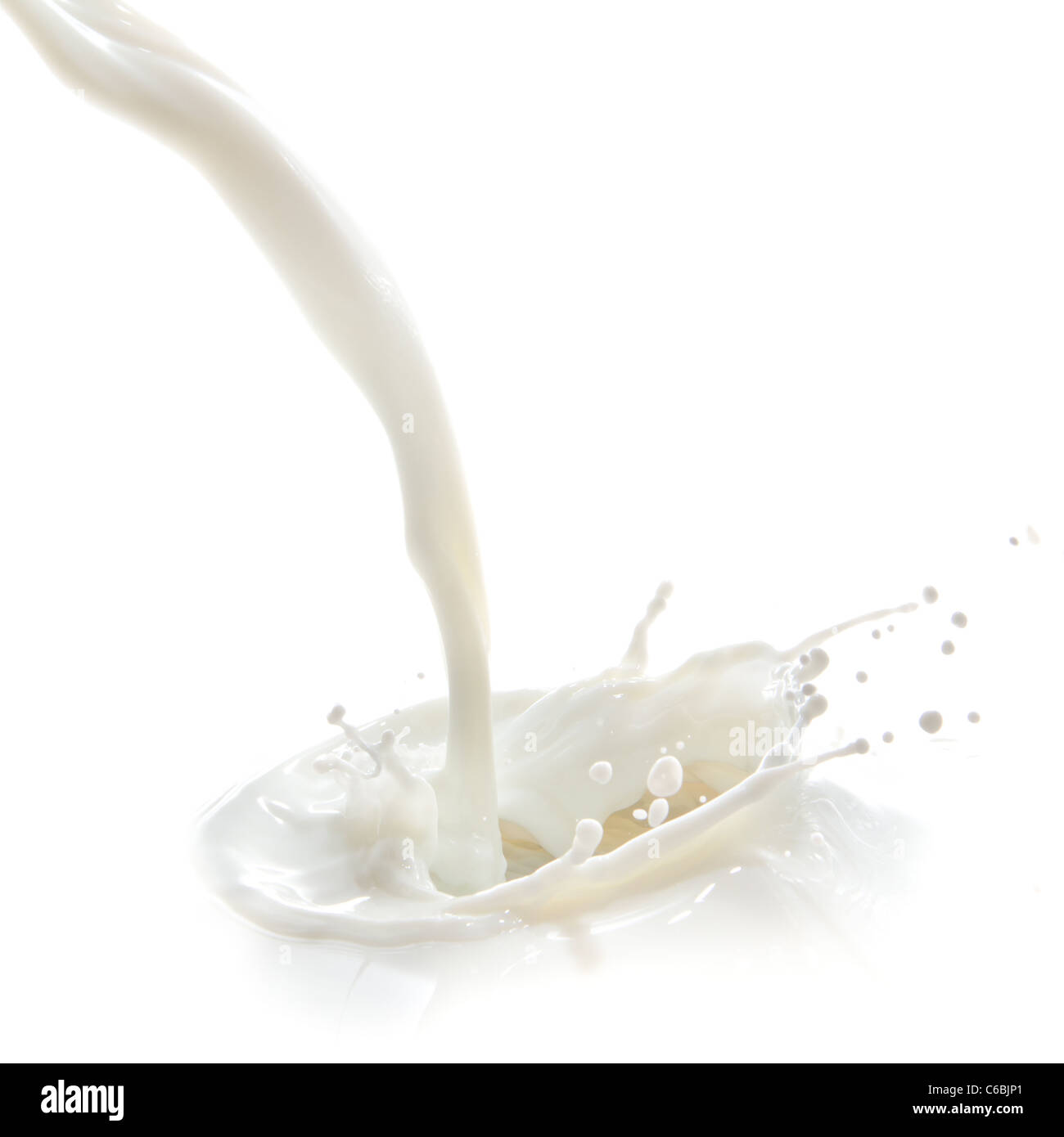 pouring milk splash isolated on white background Stock Photo - Alamy