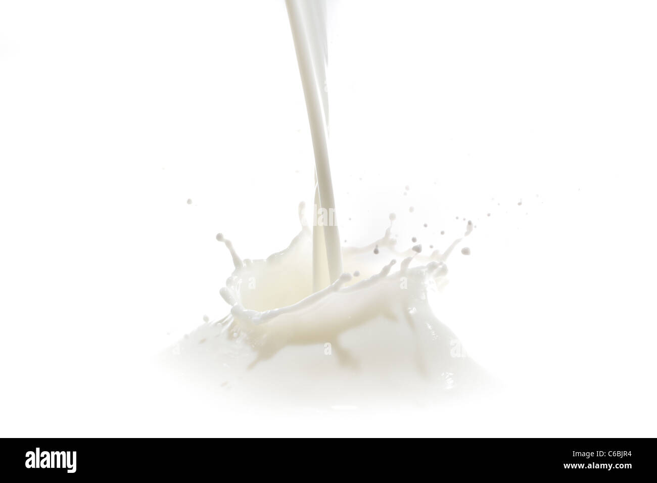 pouring milk splash isolated on white background Stock Photo - Alamy