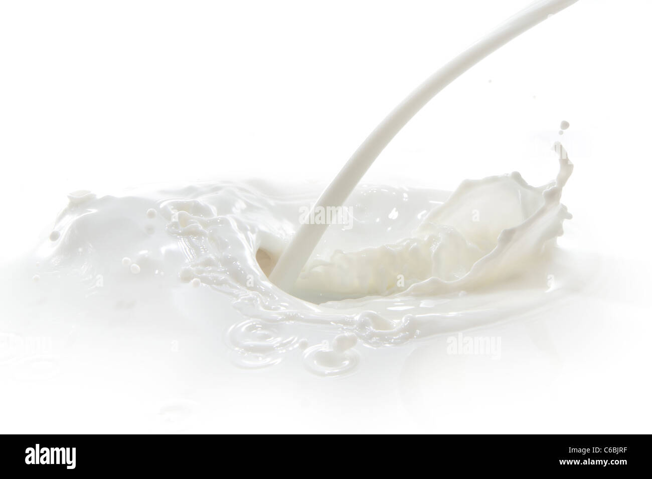 pouring milk splash isolated on white background Stock Photo - Alamy