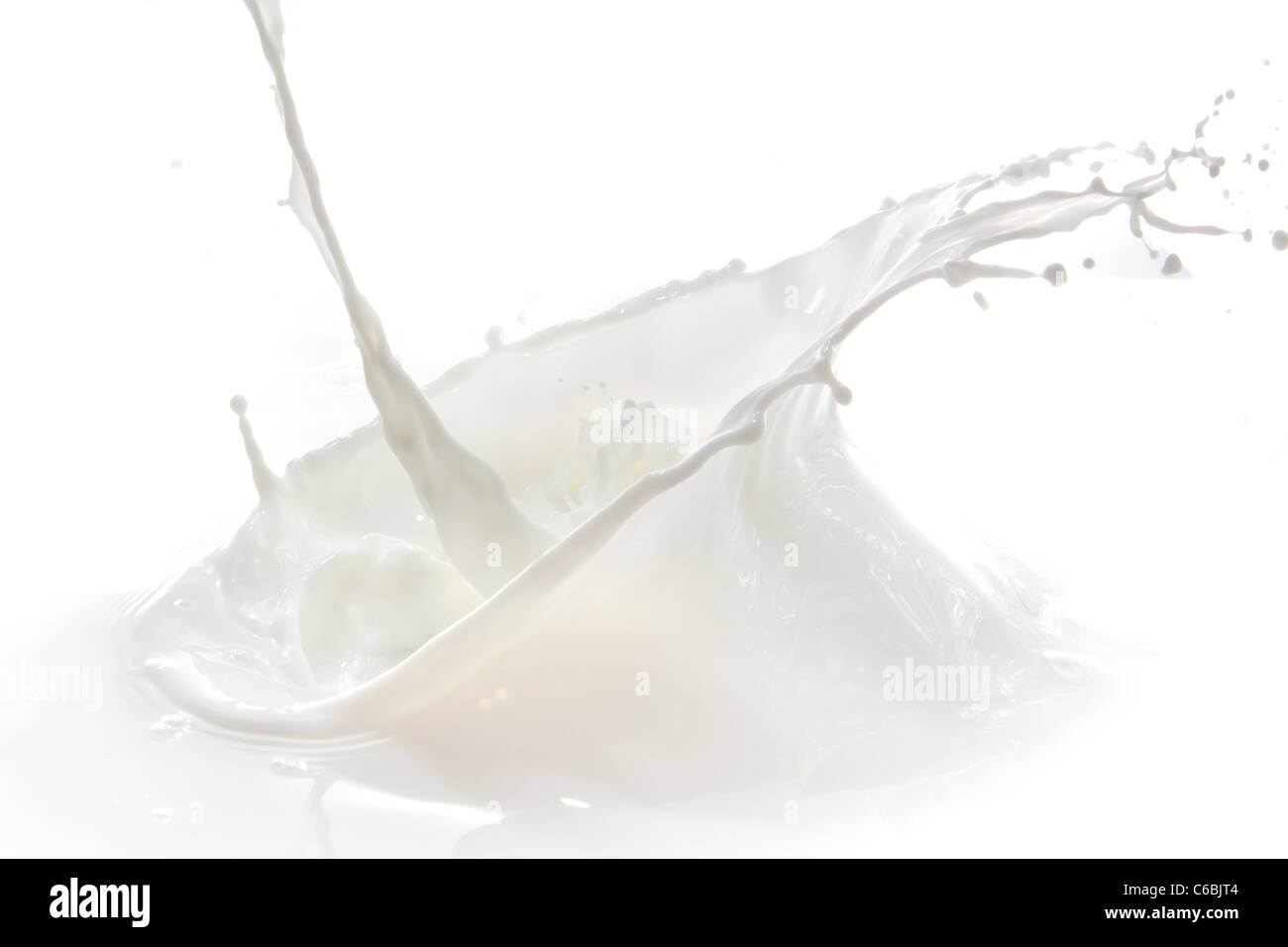 pouring milk splash isolated on white background Stock Photo - Alamy