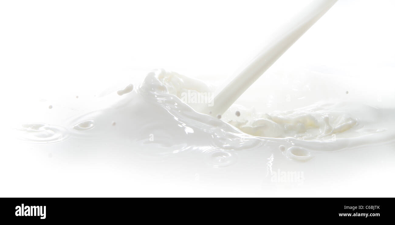 pouring milk splash isolated on white background Stock Photo - Alamy