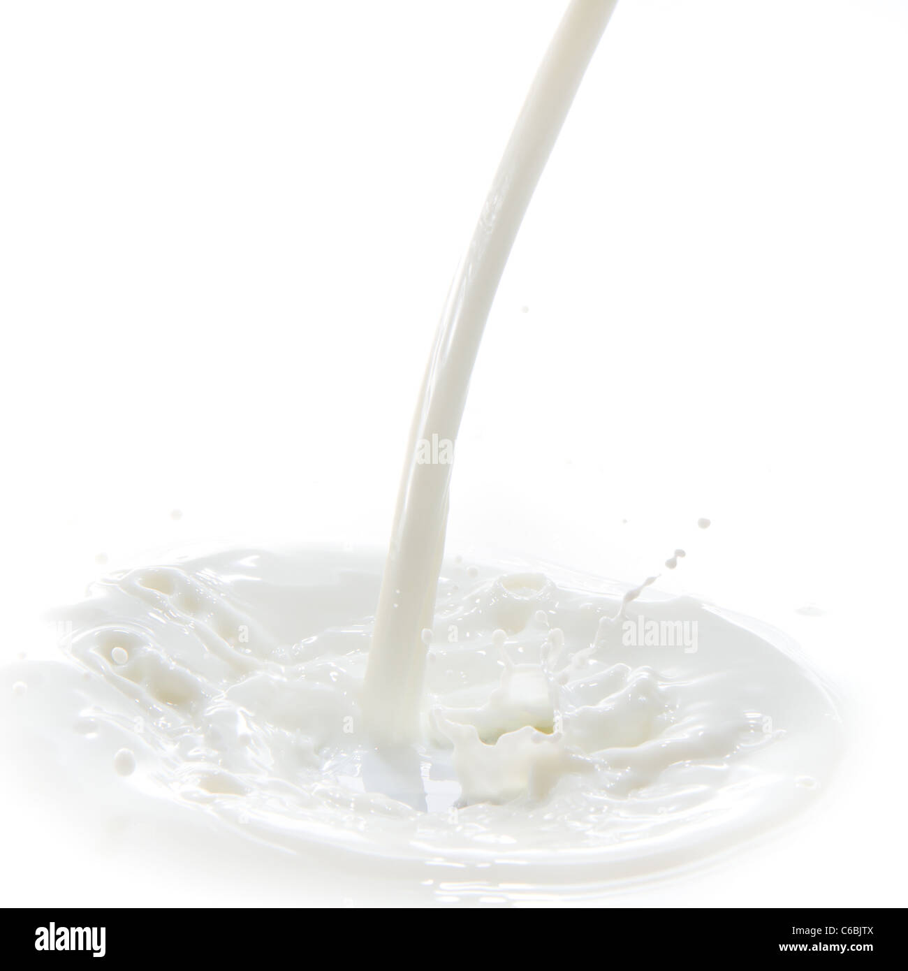pouring milk splash isolated on white background Stock Photo - Alamy