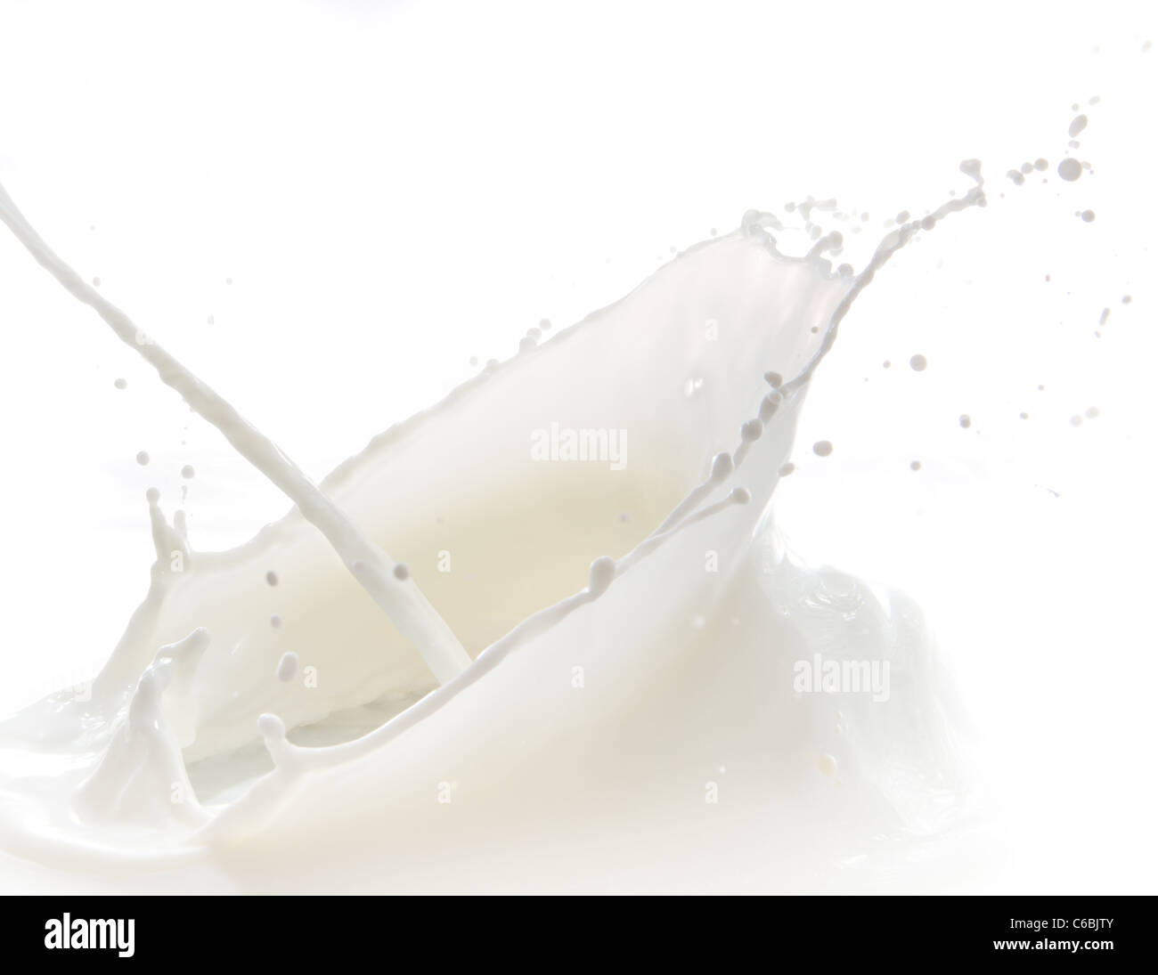 pouring milk splash isolated on white background Stock Photo - Alamy