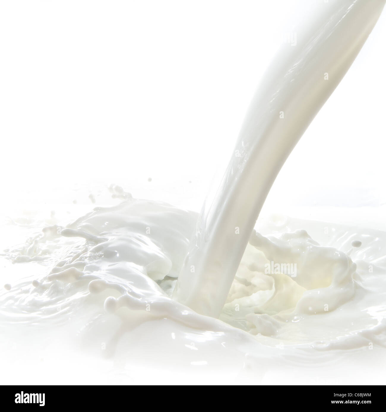 pouring milk splash isolated on white background Stock Photo - Alamy