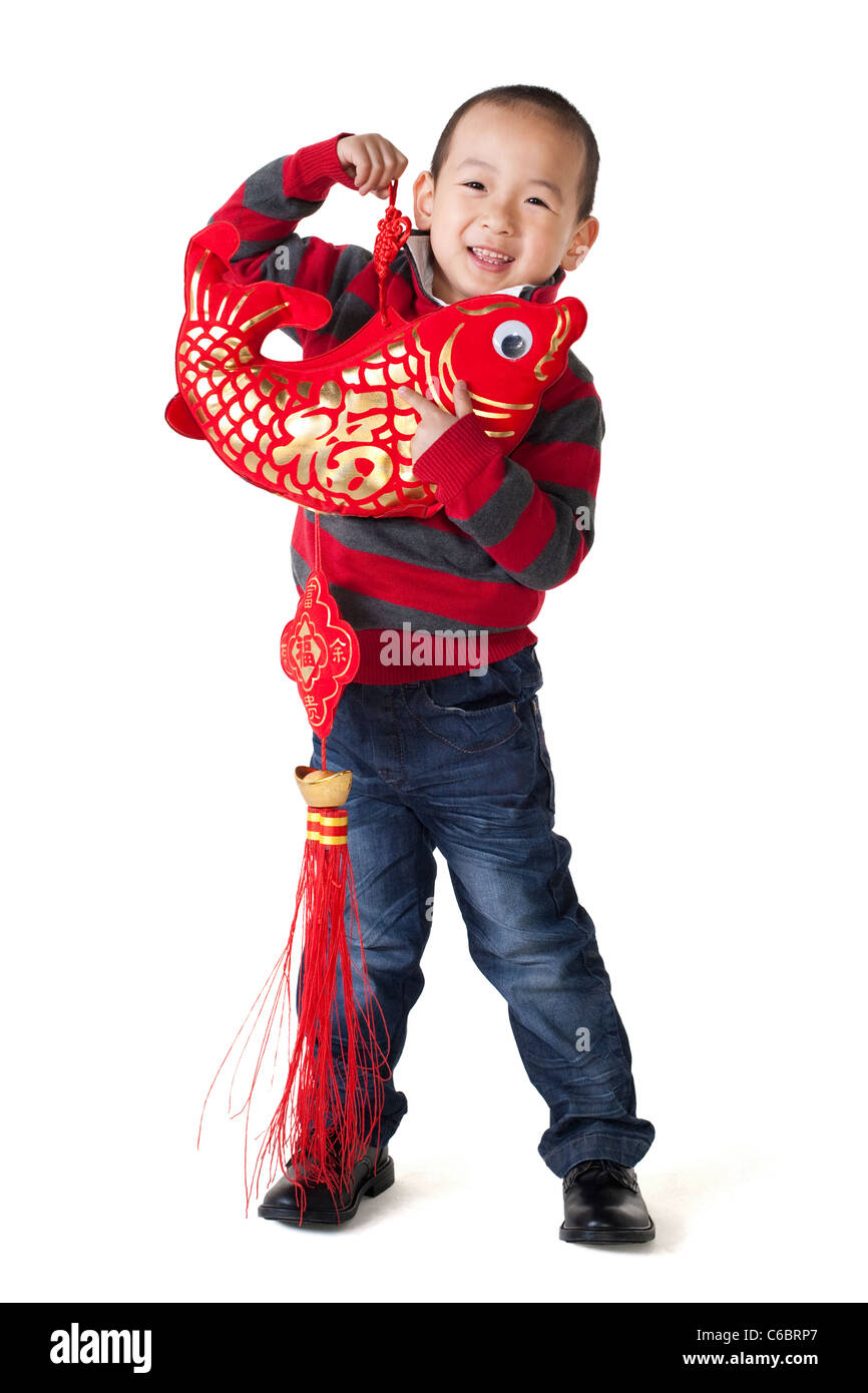 Cute Chinese boy holding Chinese fish Stock Photo - Alamy