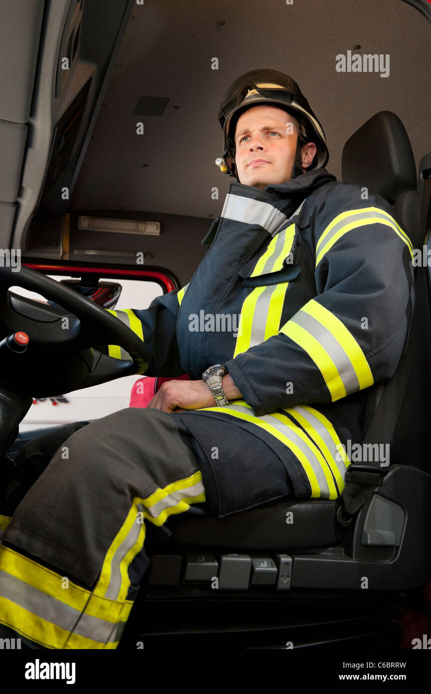 Picture from a young and successful firefighter at work Stock Photo - Alamy