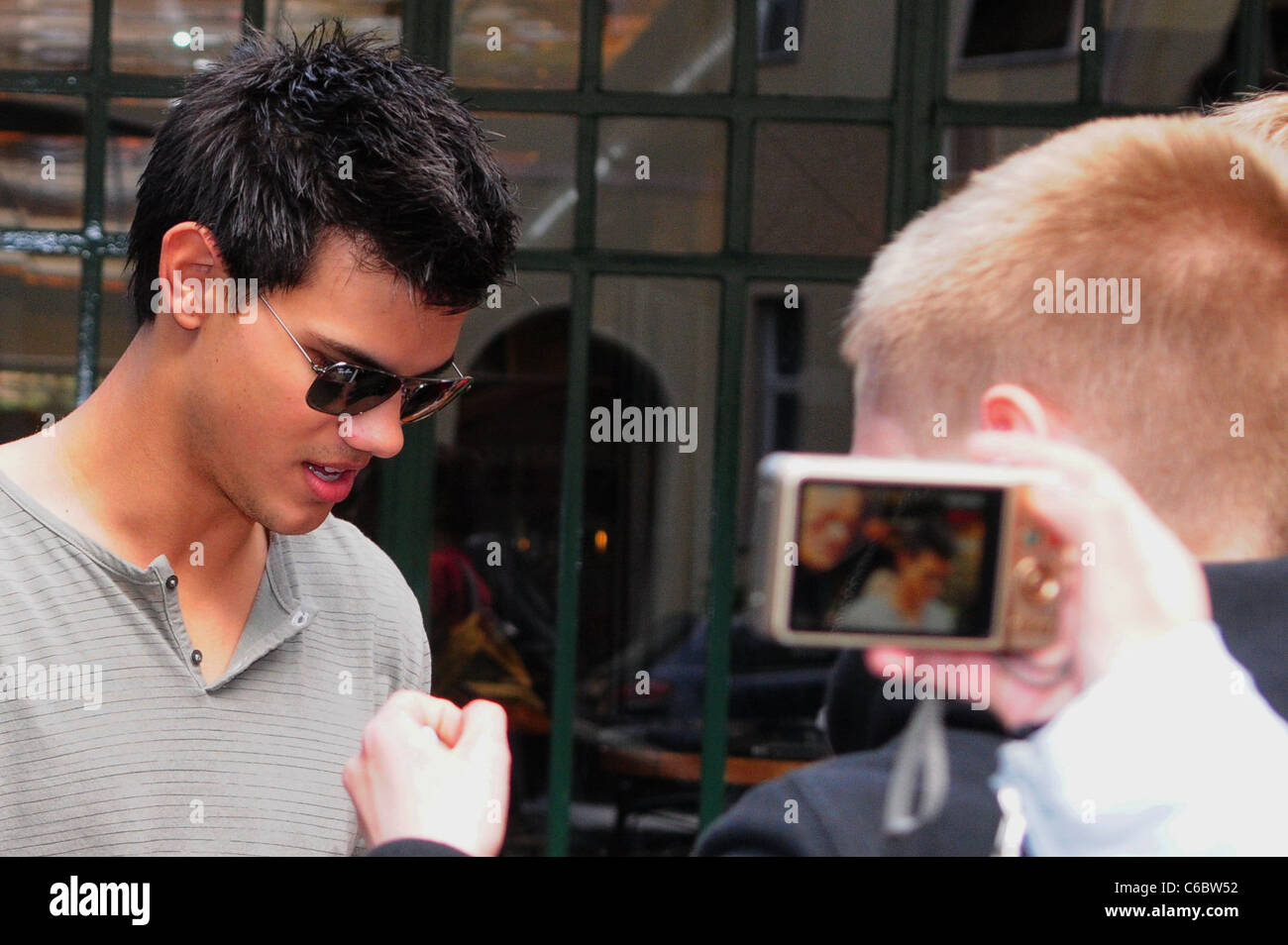 Taylor Lautner signing autographs and posing with fans whilst leaving ...