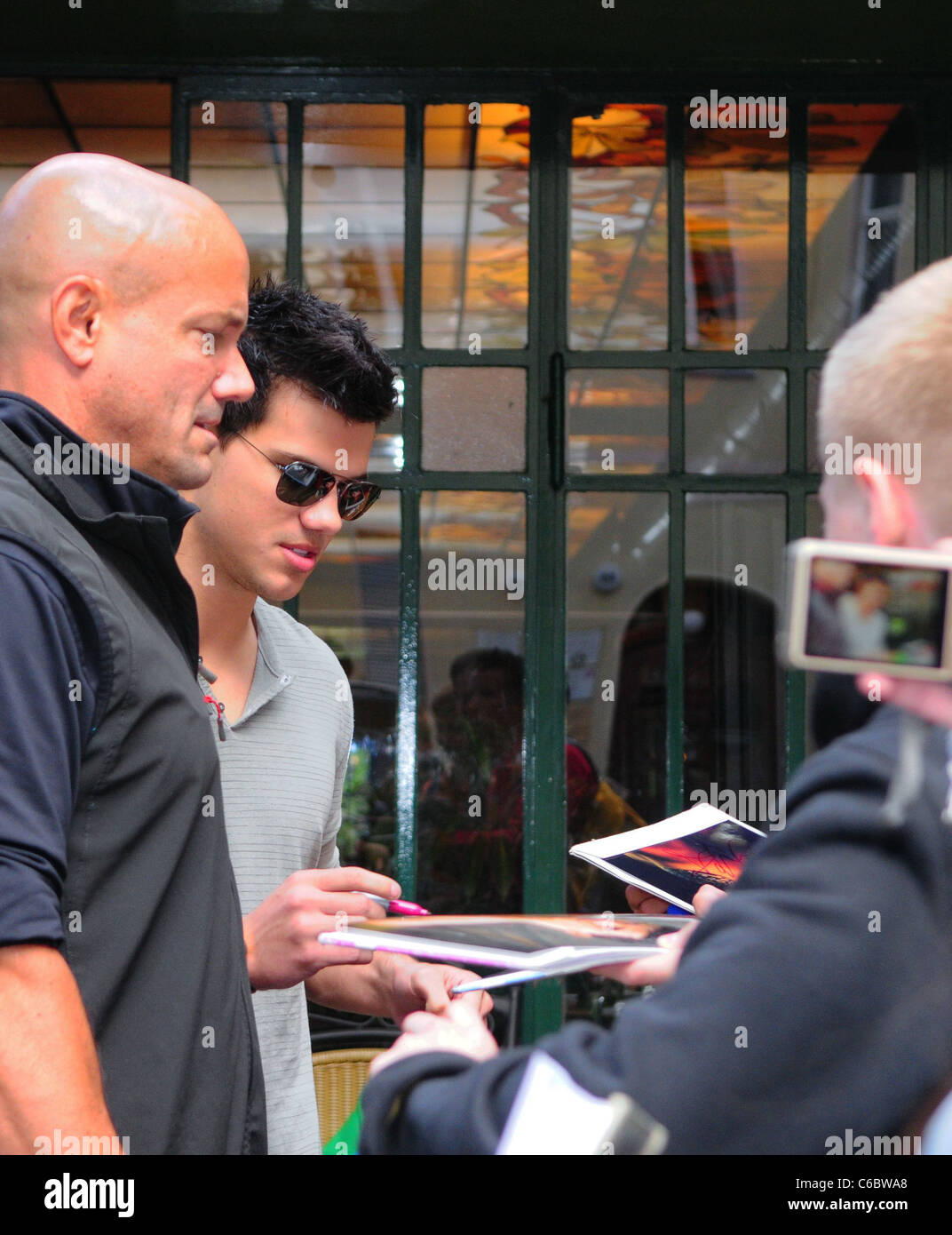 Taylor Lautner signing autographs and posing with fans whilst leaving ...