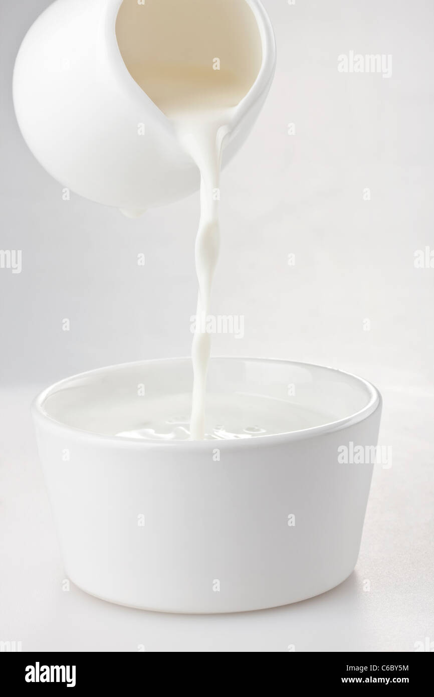 Milk Poured Into a Bowl Stock Photo - Alamy