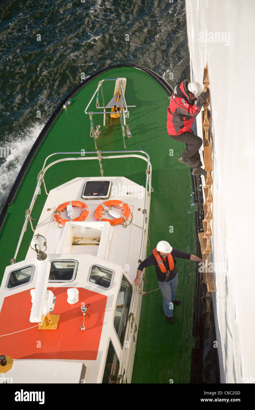 Pilot entering a ship from Pilot boat Stock Photo - Alamy