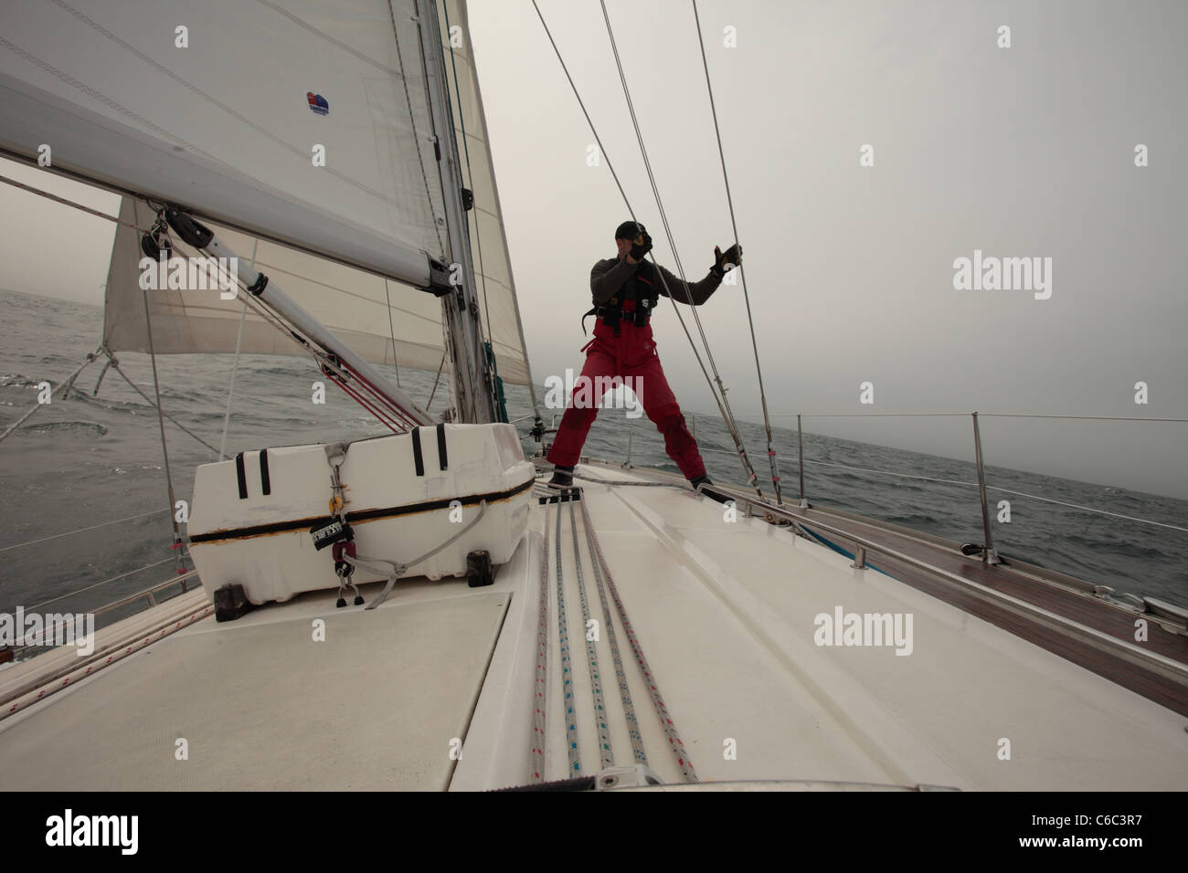sailing yacht with single crew Stock Photo - Alamy