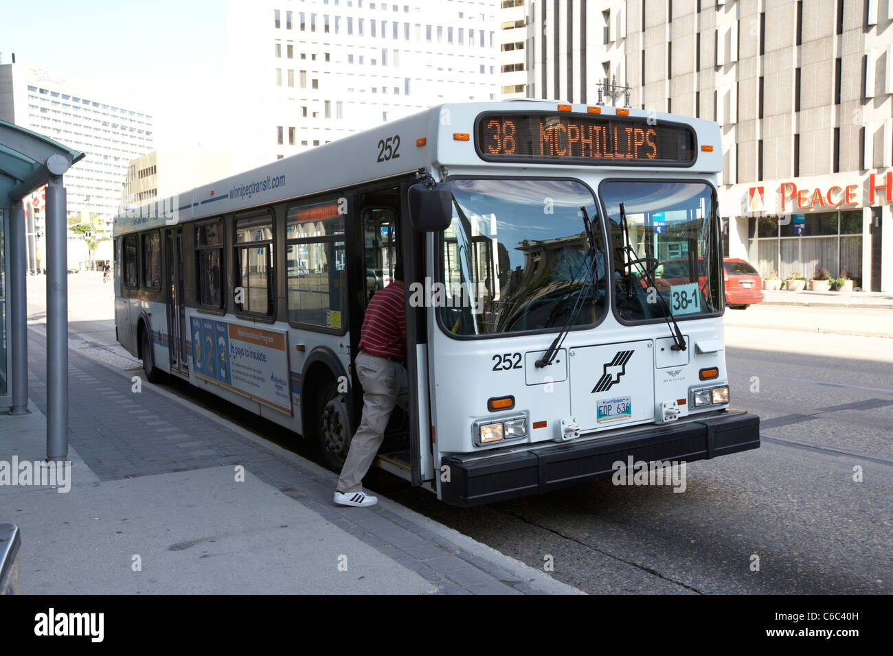 man boarding winnipeg transit bus on portage avenue downtown winnipeg ...