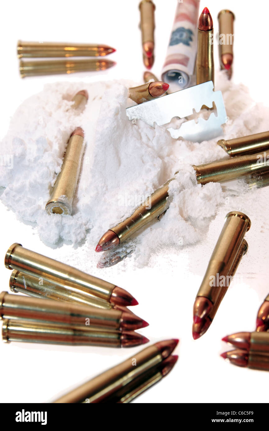 bullets and drugs showing a dangerous side to life against a white ...