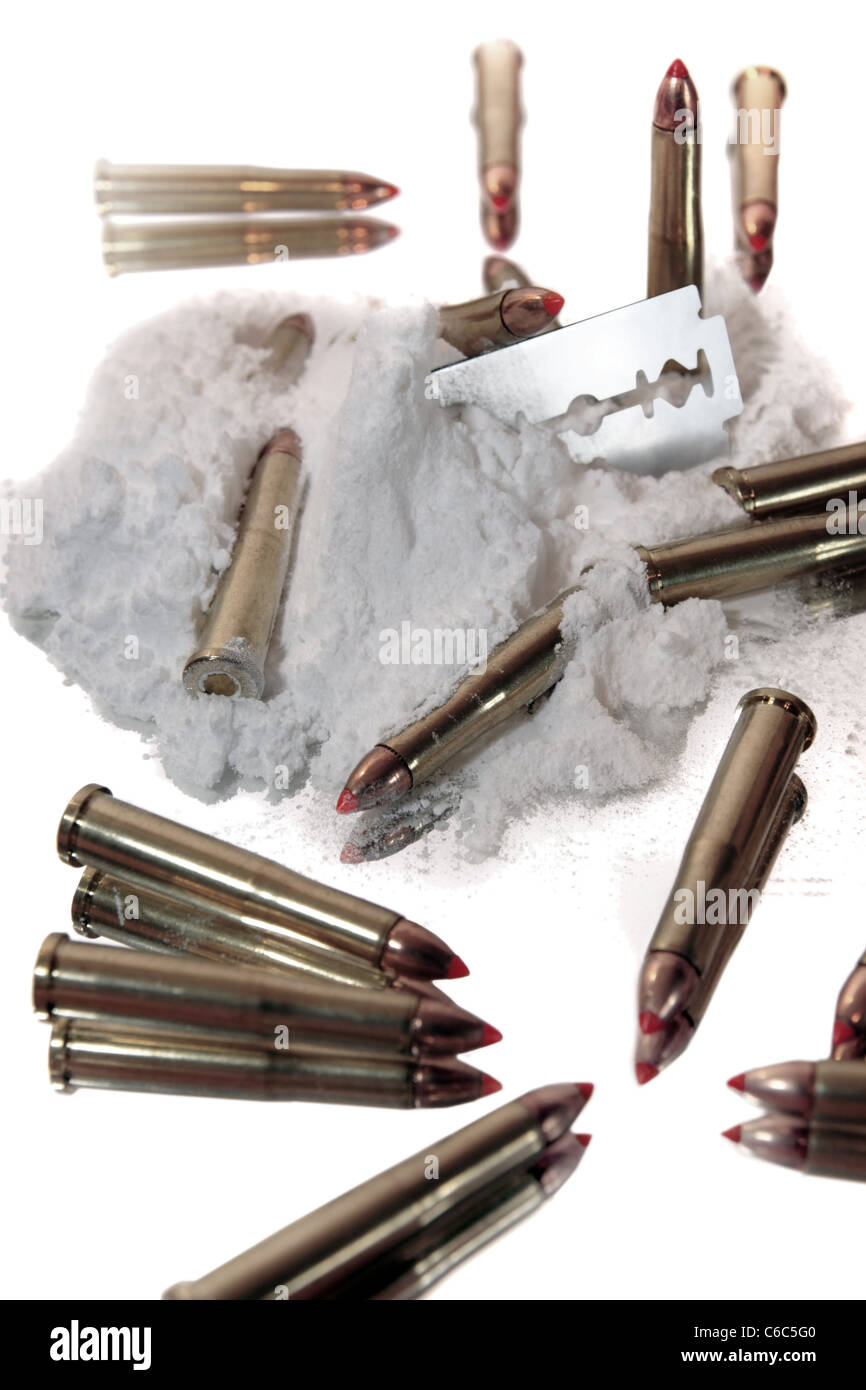 bullets and drugs showing a dangerous side to life against a white ...